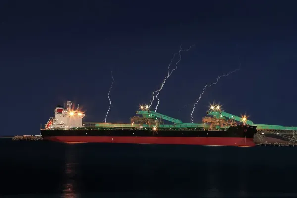Stormy dramatic sky with lightning breaking over a ship at